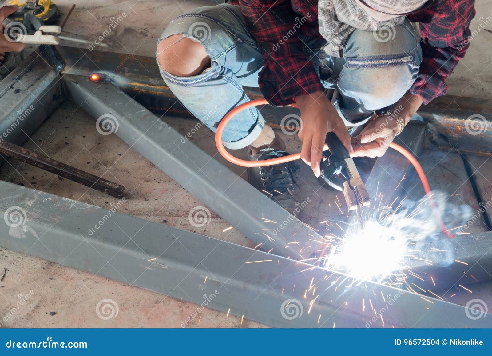 Man Weld a Metal with a Welding Machine. Stock Photo - Image of ...