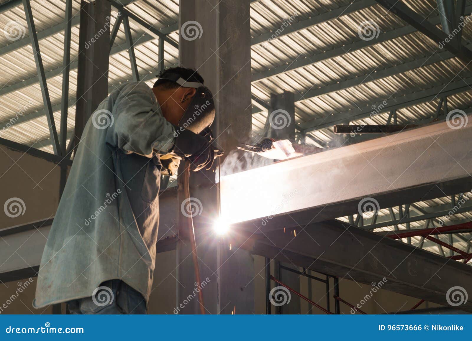 Man Weld a Metal with a Welding Machine. Stock Photo - Image of light ...