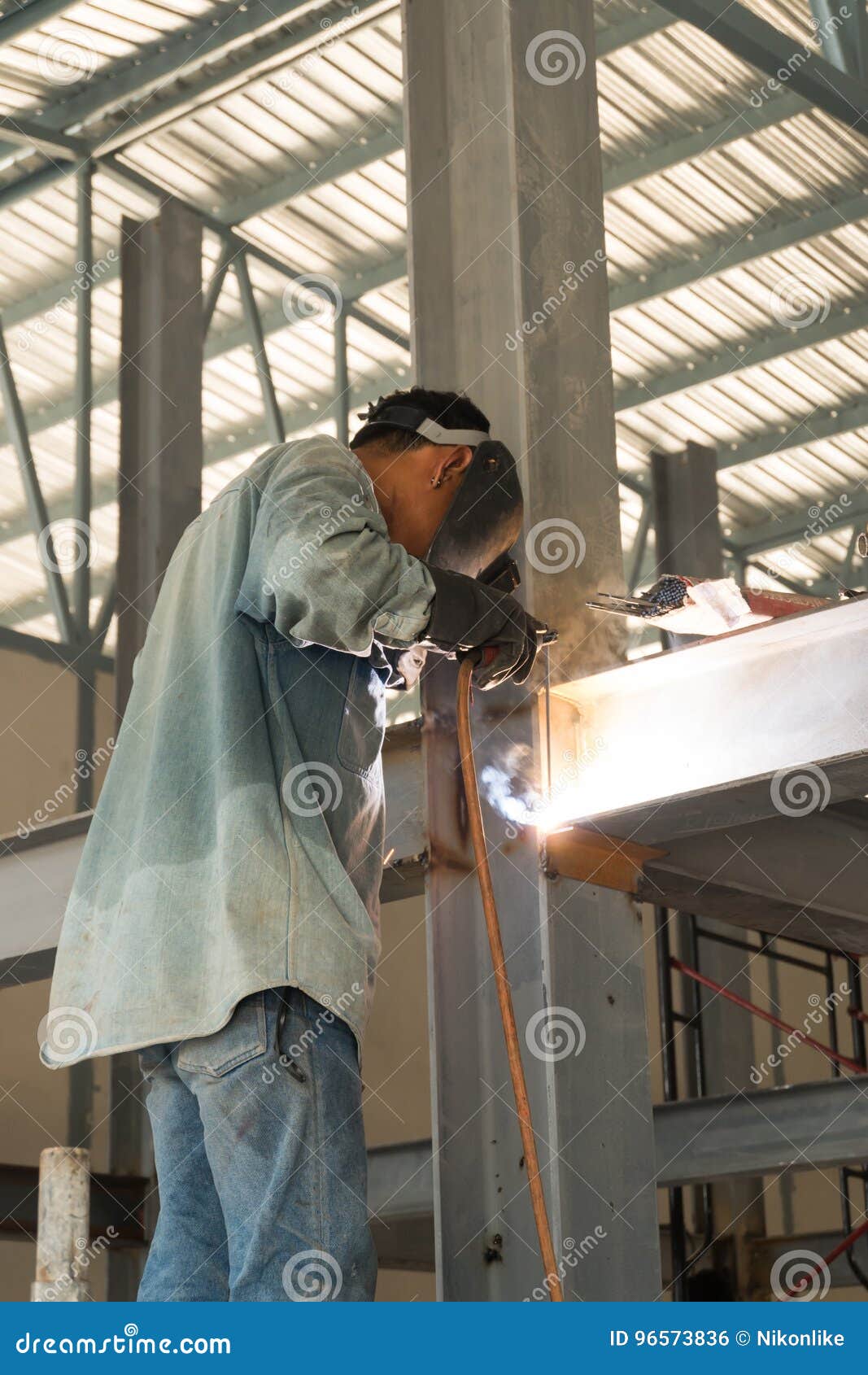 Man Weld a Metal with a Welding Machine. Stock Photo - Image of ...