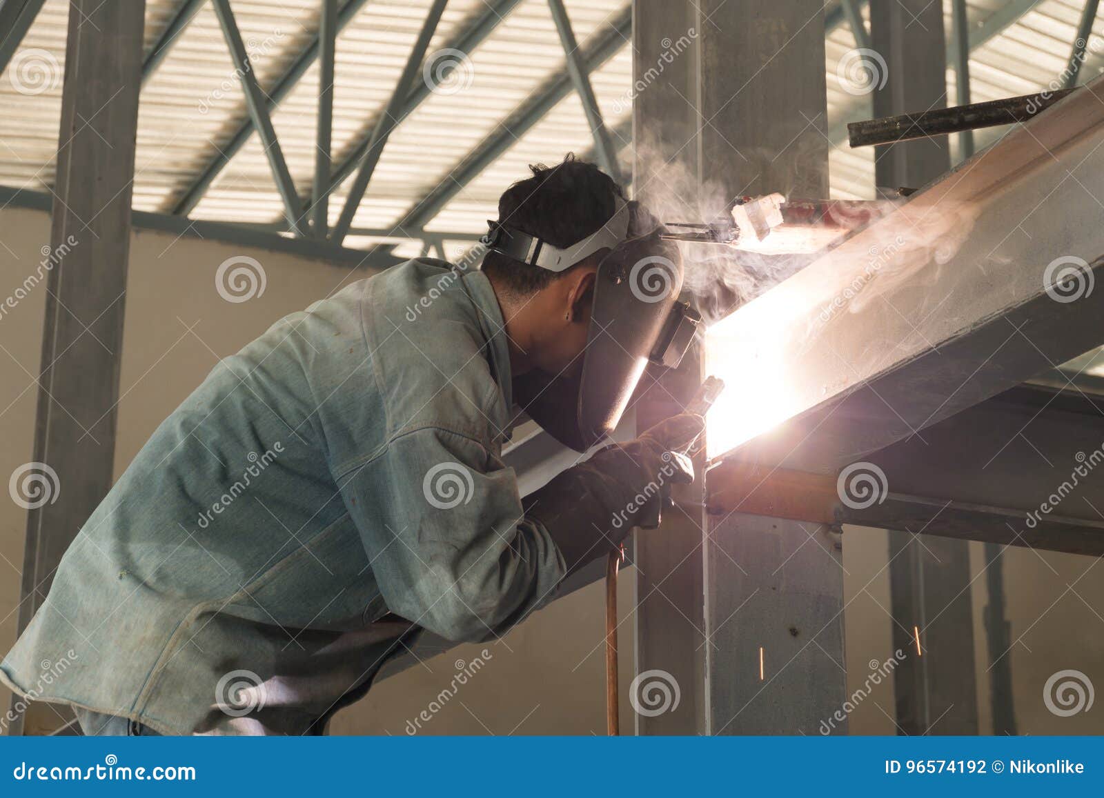 Man Weld a Metal with a Welding Machine. Stock Photo - Image of helmet ...