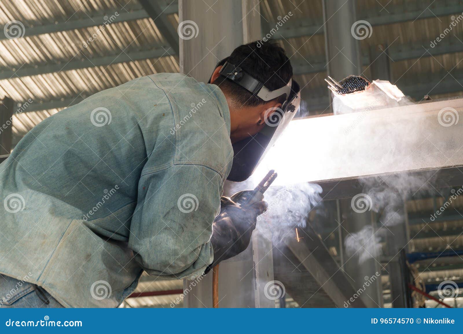Man Weld a Metal with a Welding Machine. Stock Photo - Image of ...