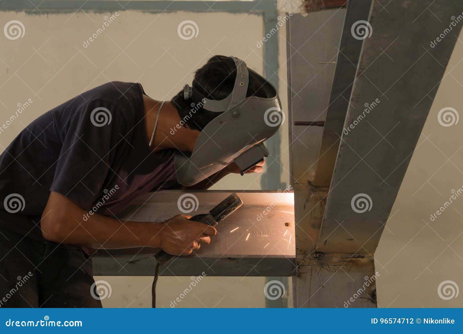 Man Weld a Metal with a Welding Machine. Stock Photo - Image of ...
