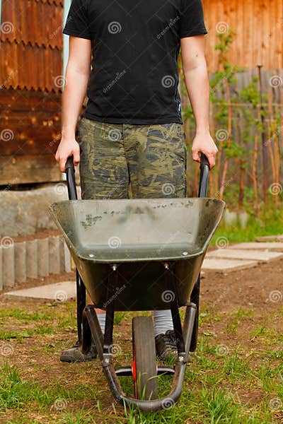 Man with wheelbarrow stock photo. Image of garden, clothes - 14417366