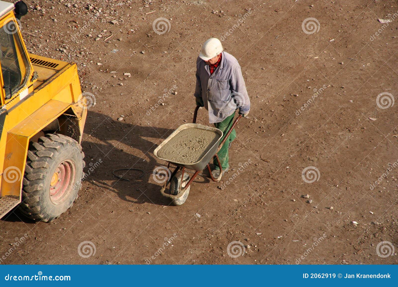 Man with Wheelbarrow stock image. Image of helmet, labour - 2062919