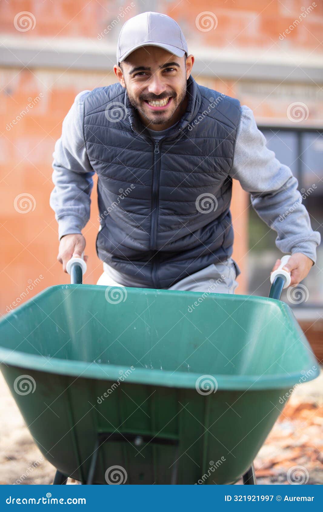 Man with Wheelbarrow at Construction Site Stock Image - Image of ...