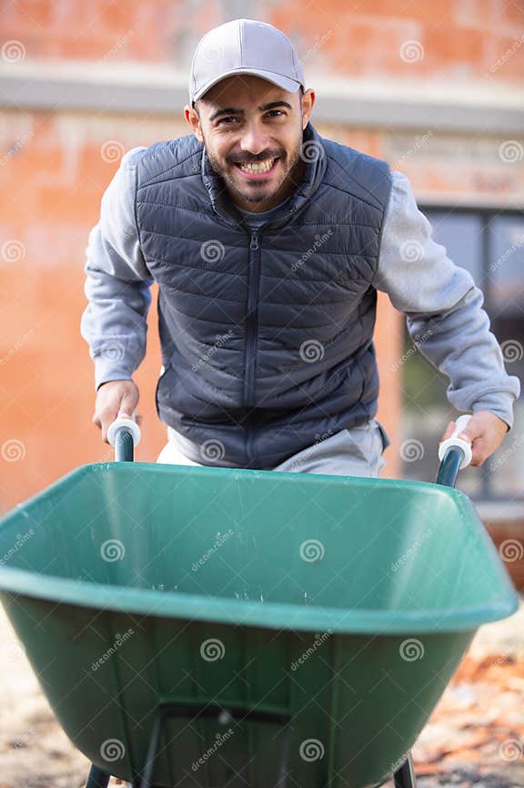 Man with Wheelbarrow at Construction Site Stock Image - Image of ...