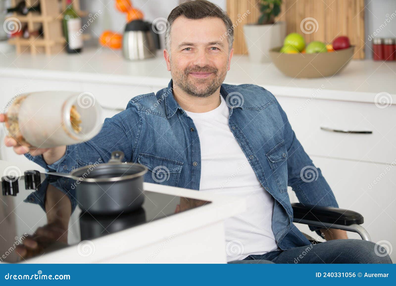 Man in wheelchair cooking stock photo. Image of inside - 240331056