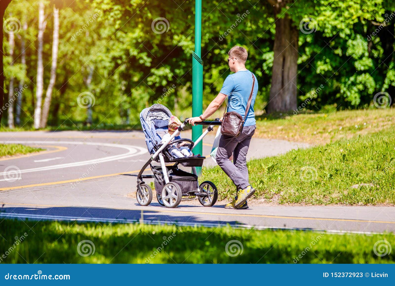 Man wheeling a pram editorial stock photo. Image of pram - 152372923