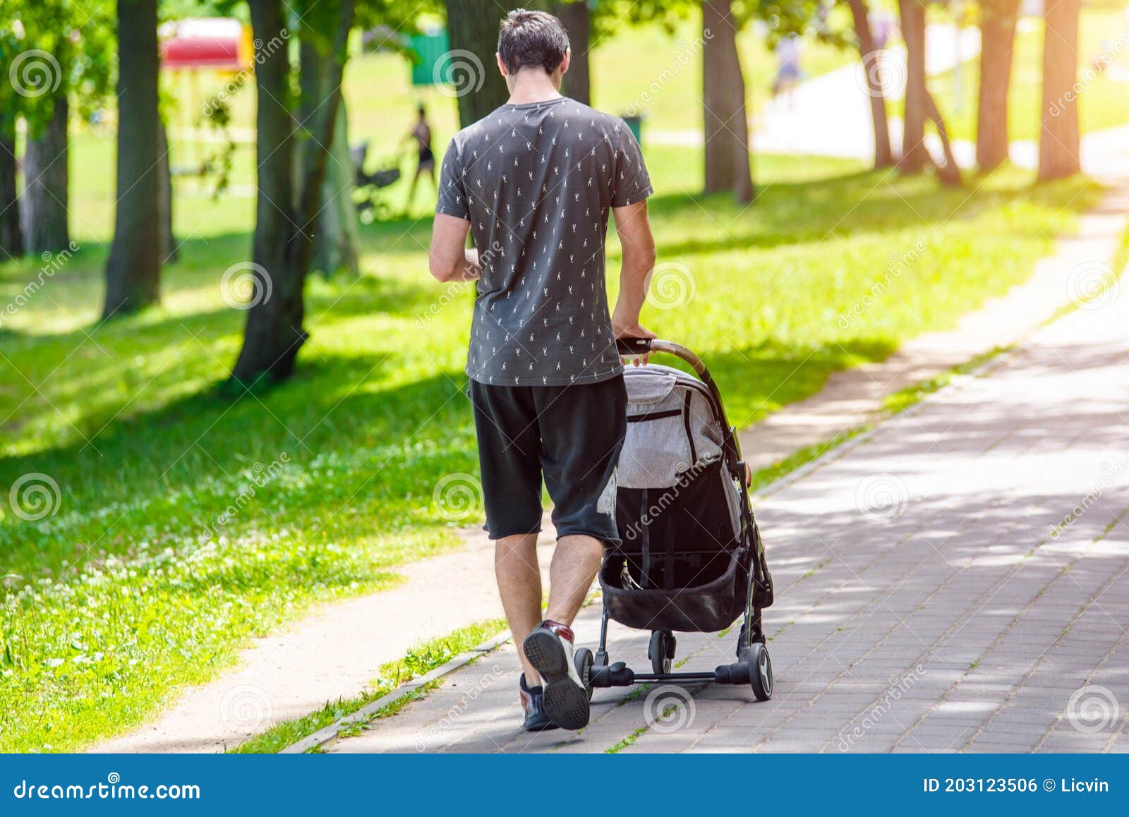 Man wheeling a pram stock photo. Image of walk, spring - 203123506