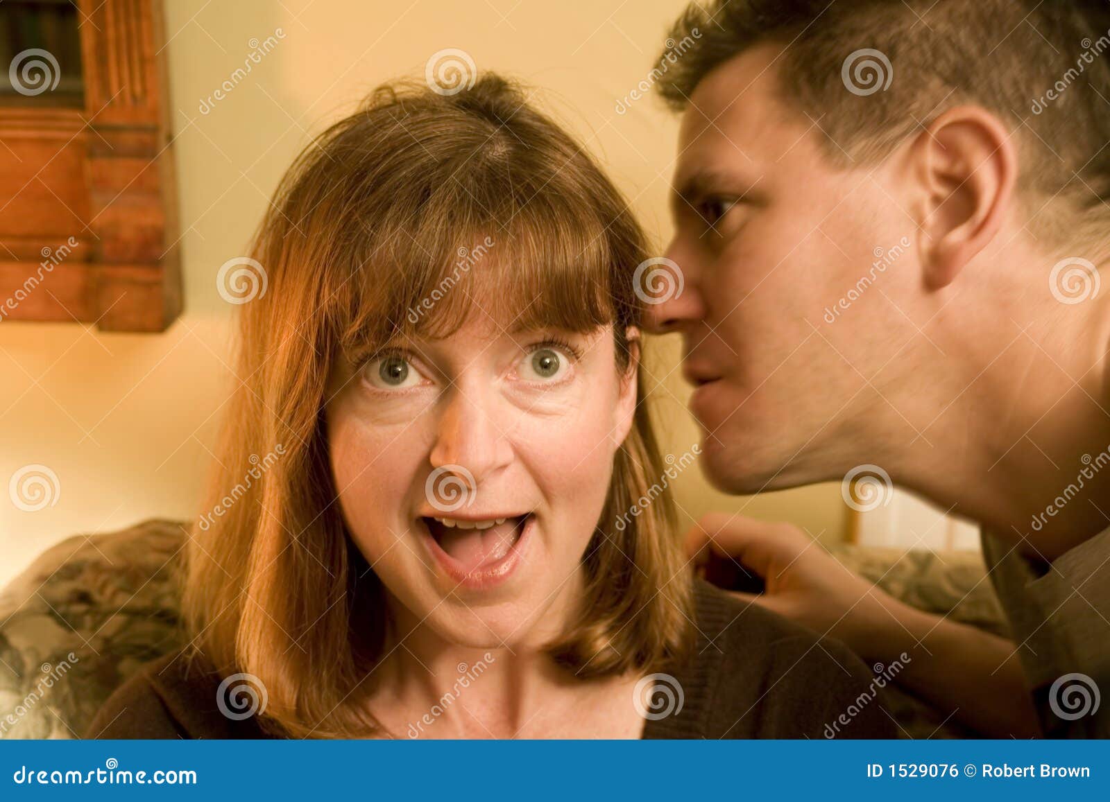 Man Whispering in Ear of Woman Stock Photo - Image of aghast, open: 1529076