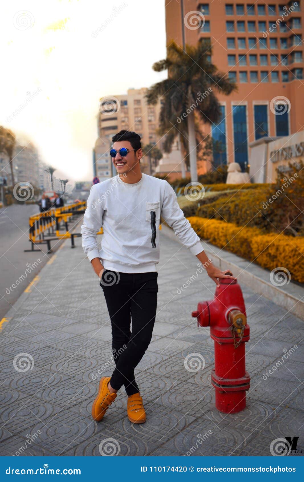 Man In White Long-sleeved Shirt Holding Red Fire Hydrant Picture. Image ...