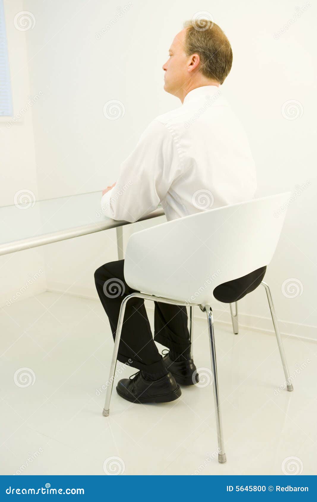 Man in white room at table stock photo. Image of away - 5645800