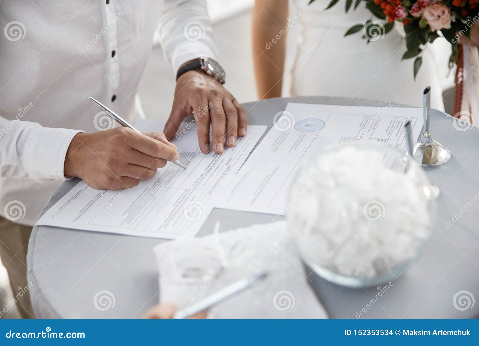 A Man in a White Shirt is Signing Up a Document in a Registry Office ...