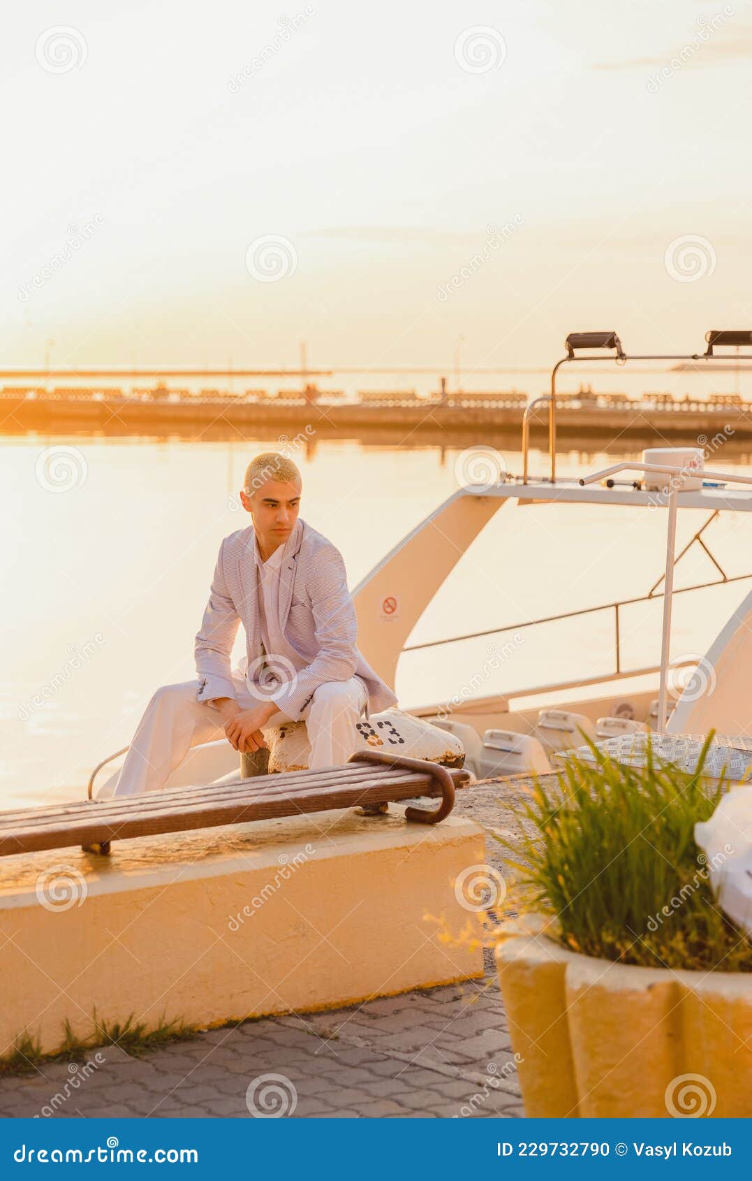 A Man in a Suit Sits on the Shore Stock Photo - Image of male ...