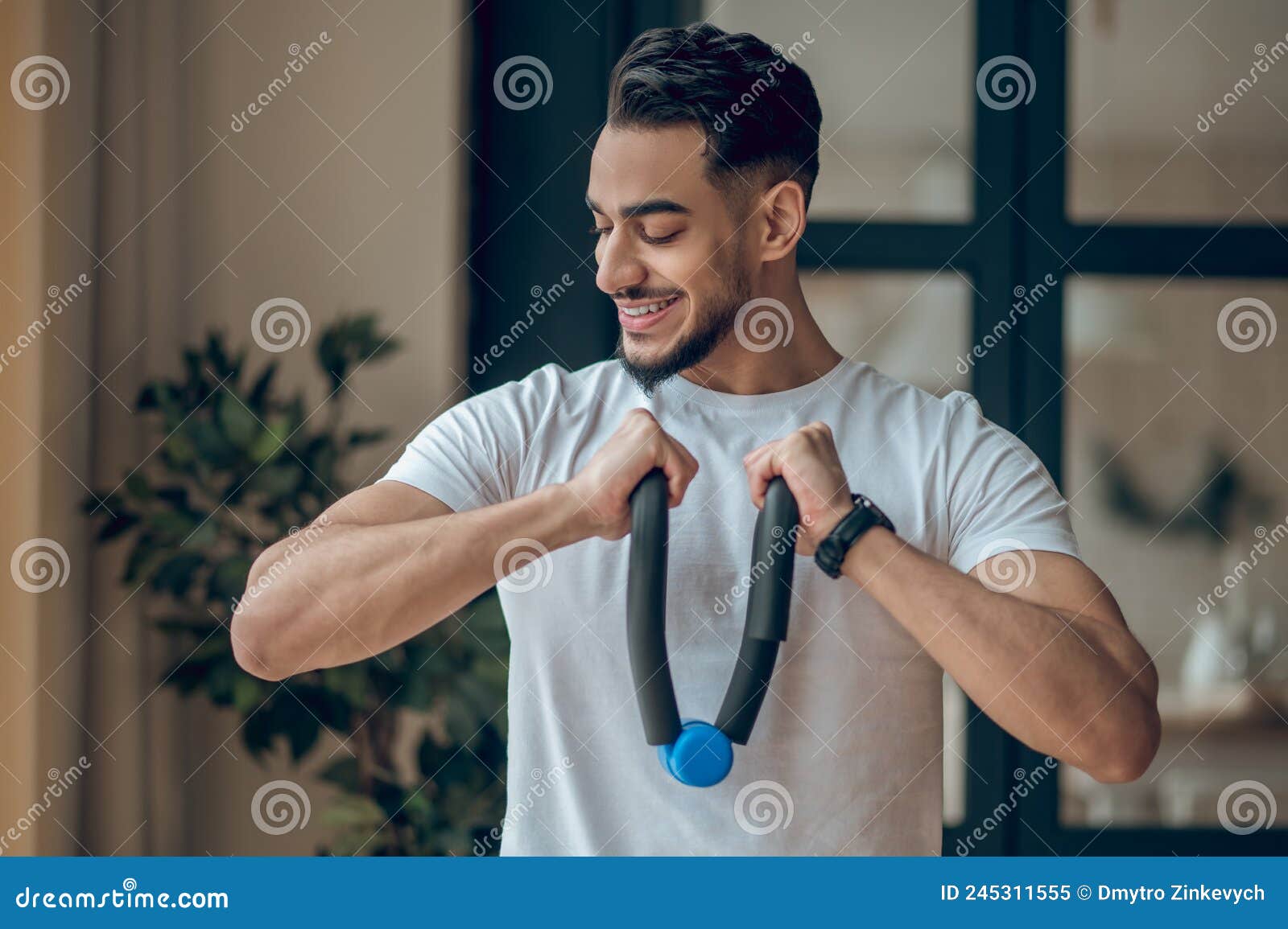 A Man in a White Tshirt Exercising with Expander Stock Image - Image of ...