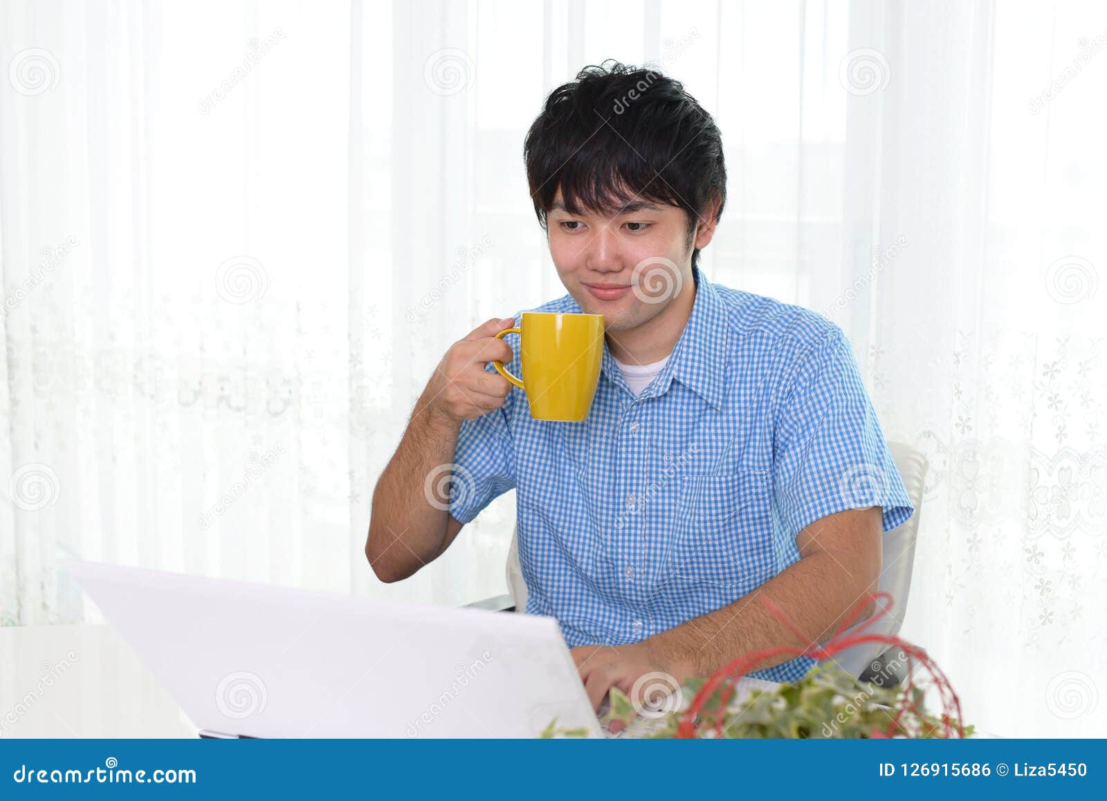 Asian man using a laptop stock photo. Image of handsome - 126915686