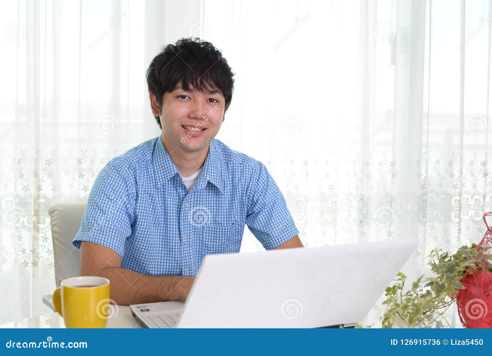 Asian man using a laptop stock photo. Image of holiday - 126915736