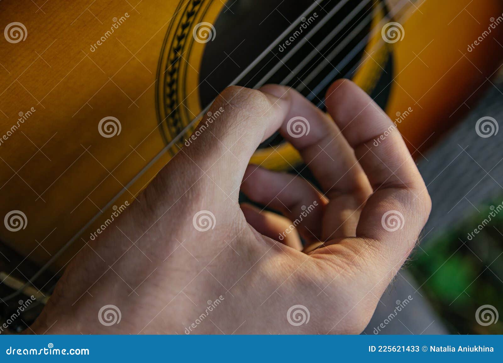 A Man, Whose Face is Not Visible, Plays the Guitar on a Musical ...