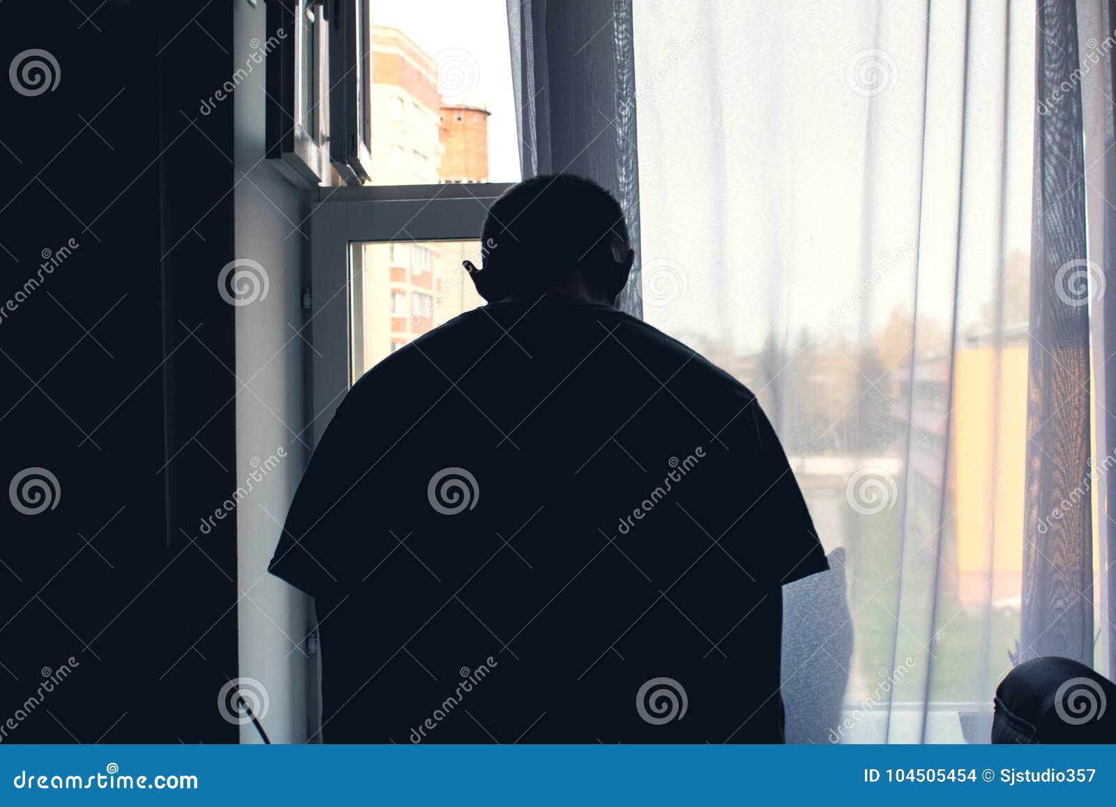 The Man at the Window, Bending His Head Down in Depression, Wants To ...