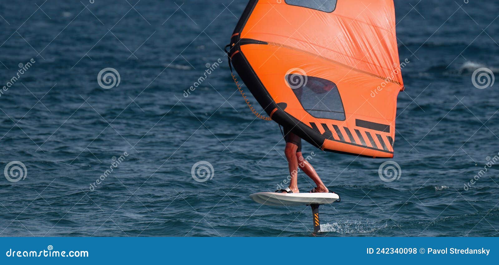 A Man is Wing Foiling Using Handheld Inflatable Wings and Hydrofoil ...