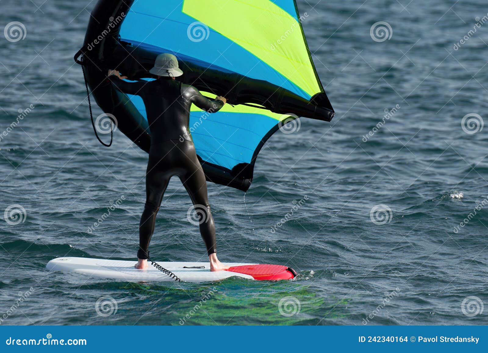 A Man is Wing Foiling Using Handheld Inflatable Wings and Hydrofoil ...