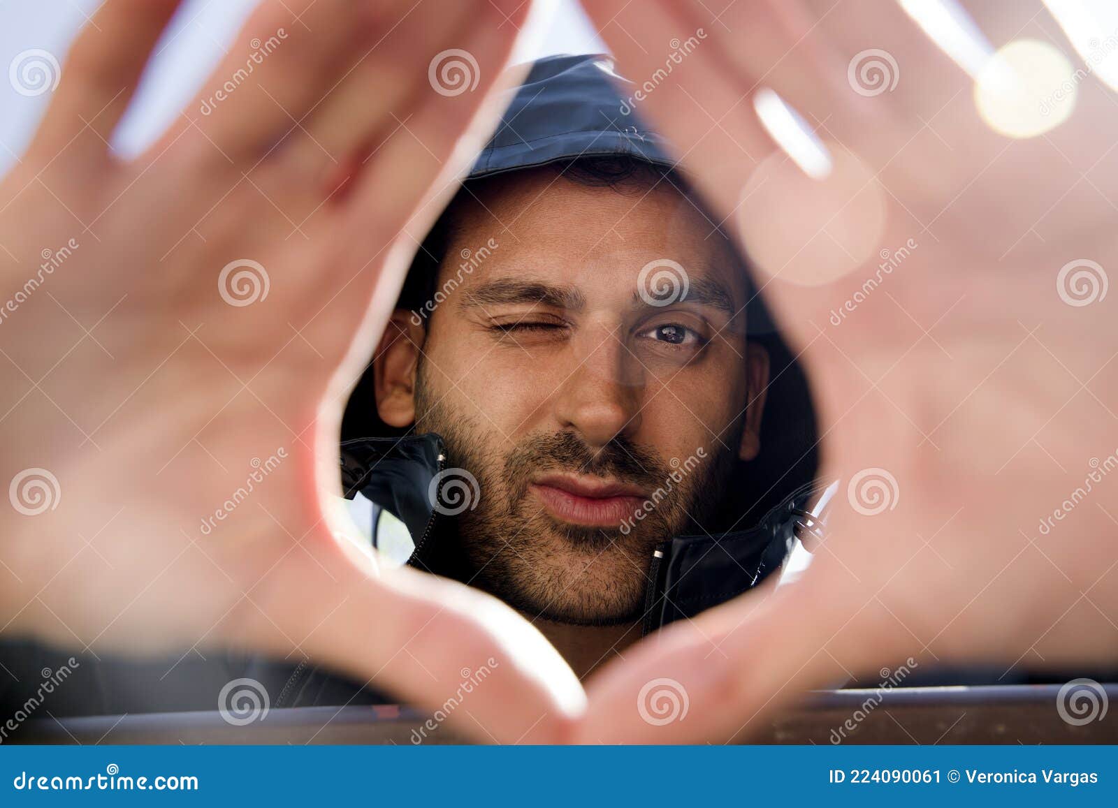 Man Winking and Framing His Face with His Hands Stock Image - Image of ...