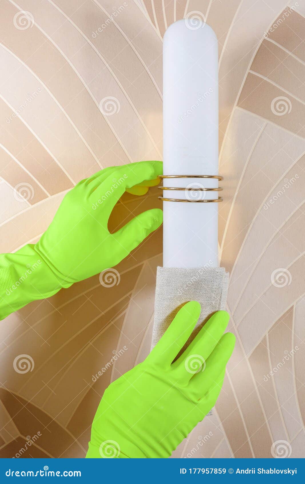 A Man Wipes the Dust from a Lamp. Cleaning Service Stock Image - Image ...