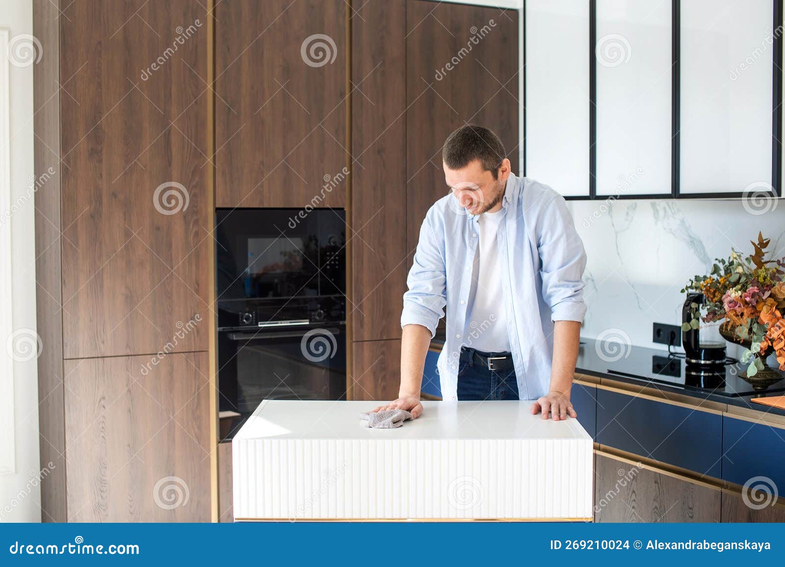 A Man Wipes a Table in the Kitchen. Wipe the Crumbs Off the Table with ...