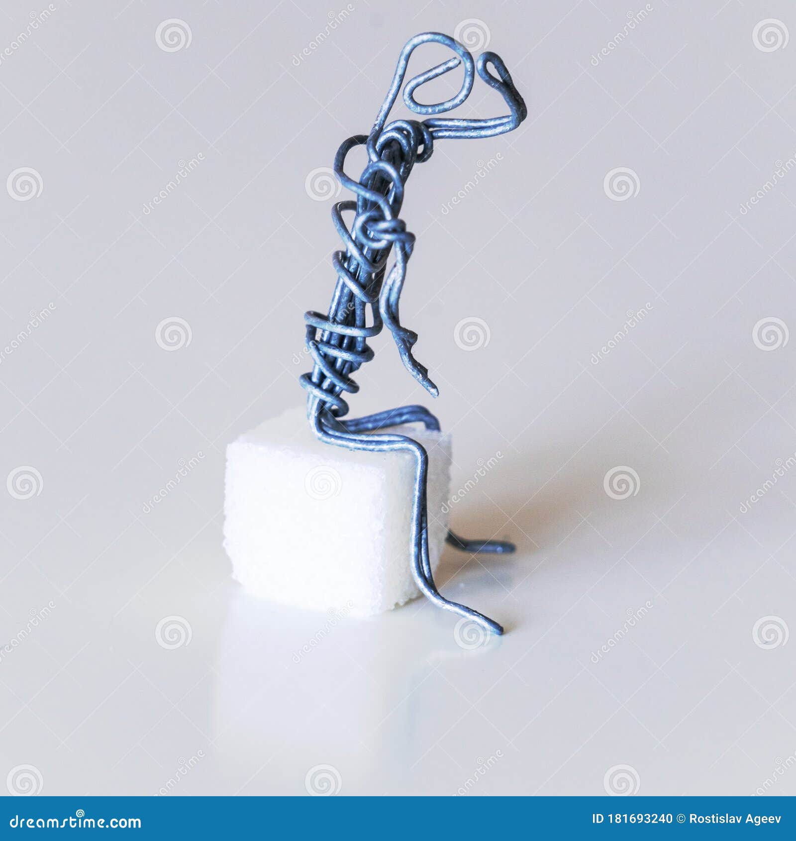 A Man of Wire Sits in the Pose of a Thinker, Raising His Hand To His ...