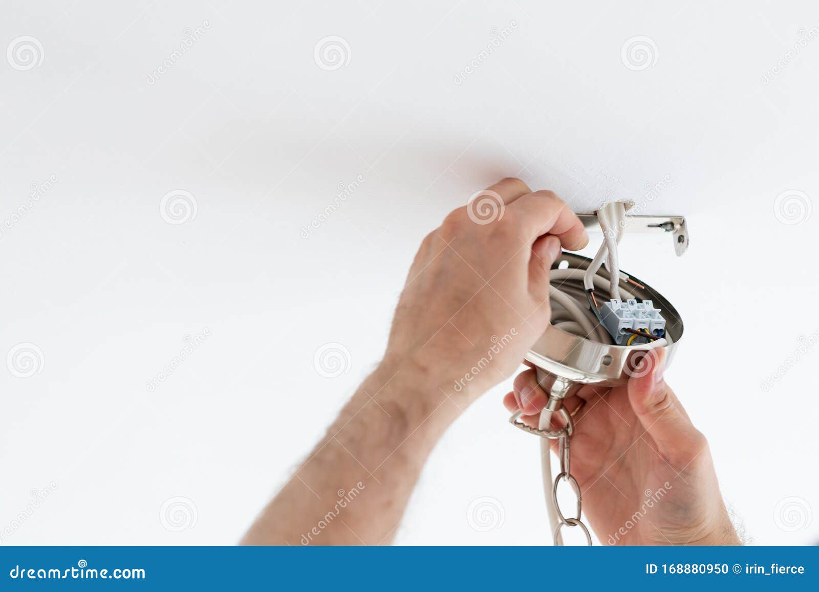 Man Wiring Ceiling Light on White Background Stock Photo - Image of ...