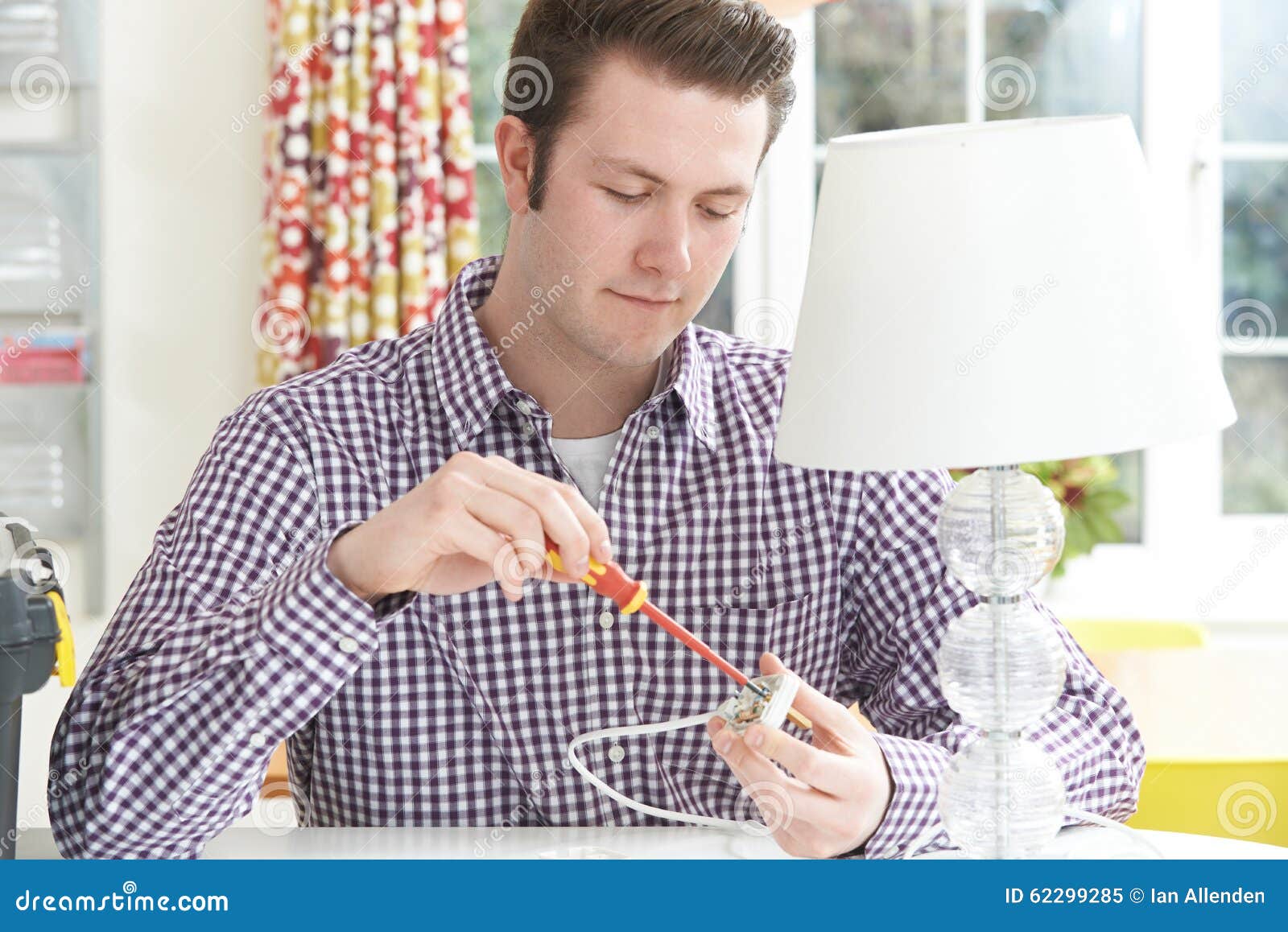 Man Wiring Electrical Plug on Lamp at Home Stock Image - Image of ...