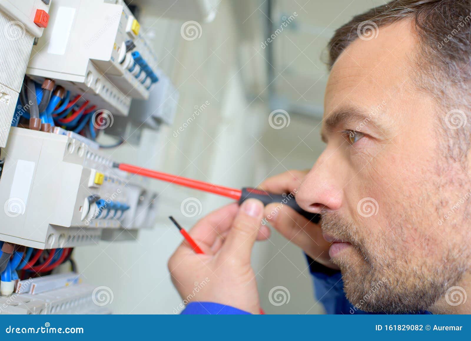 Man wiring fuse into box stock photo. Image of industry - 161829082