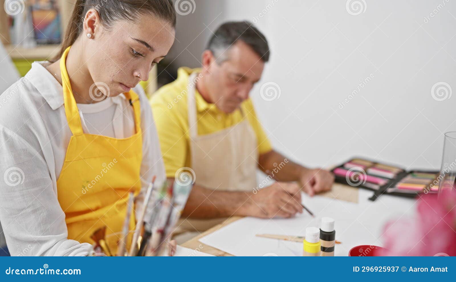 Man and Woman Artists, Deep in Concentration, Sitting Together in Art ...