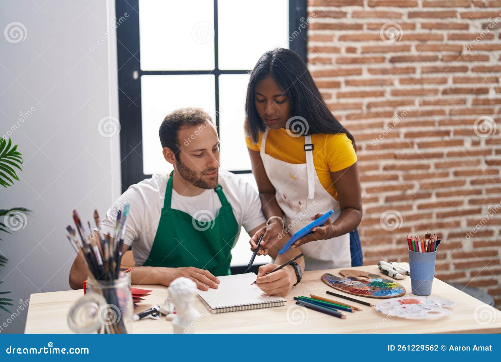 Man and Woman Artists Drawing on Notebook Using Touchpad at Art Studio ...