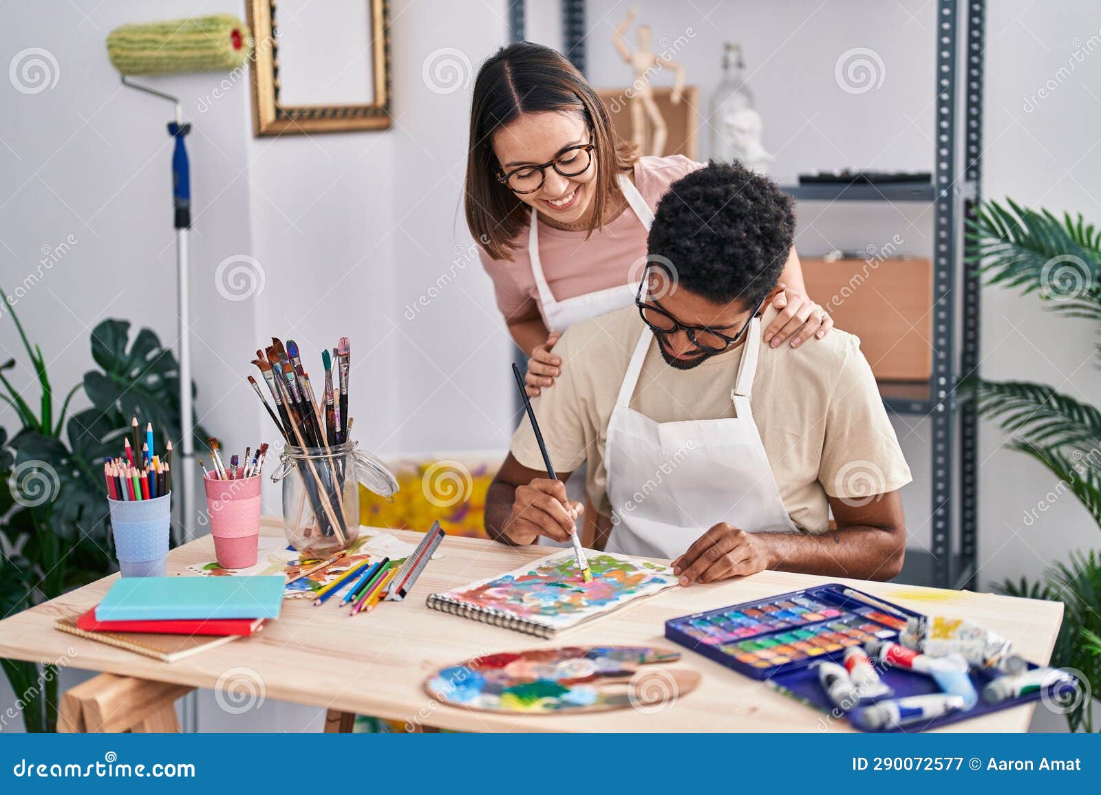 Man and Woman Artists Smiling Confident Drawing on Notebook at Art ...