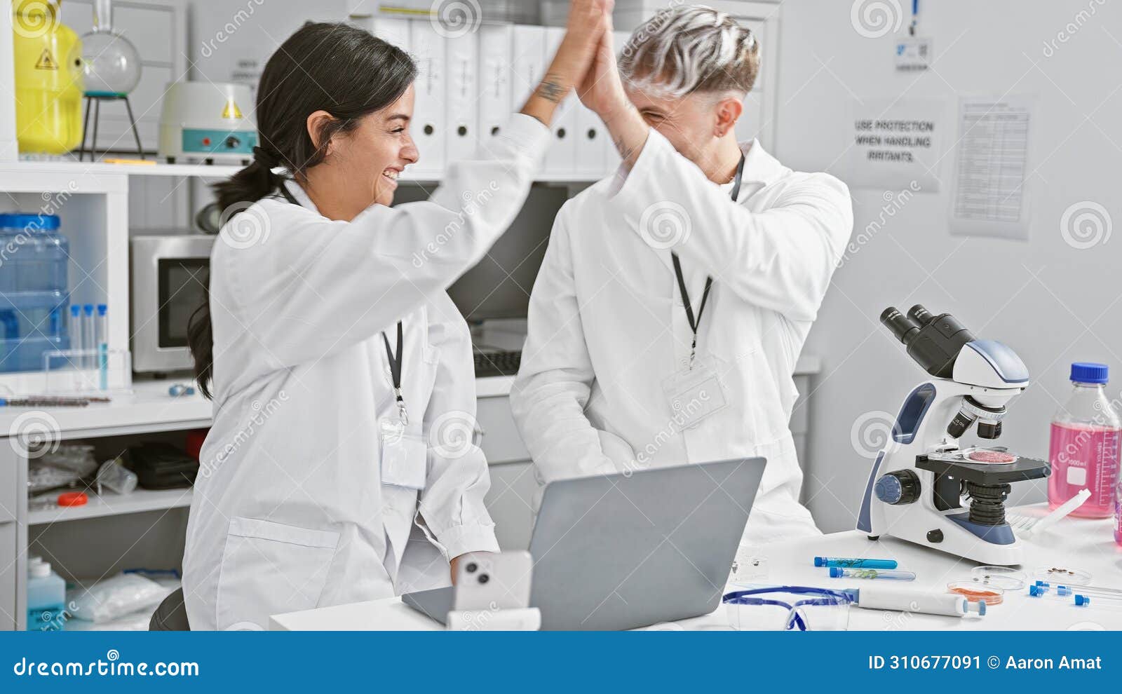 A Man and Woman, Both Scientists, Joyfully High-five Each Other in a ...