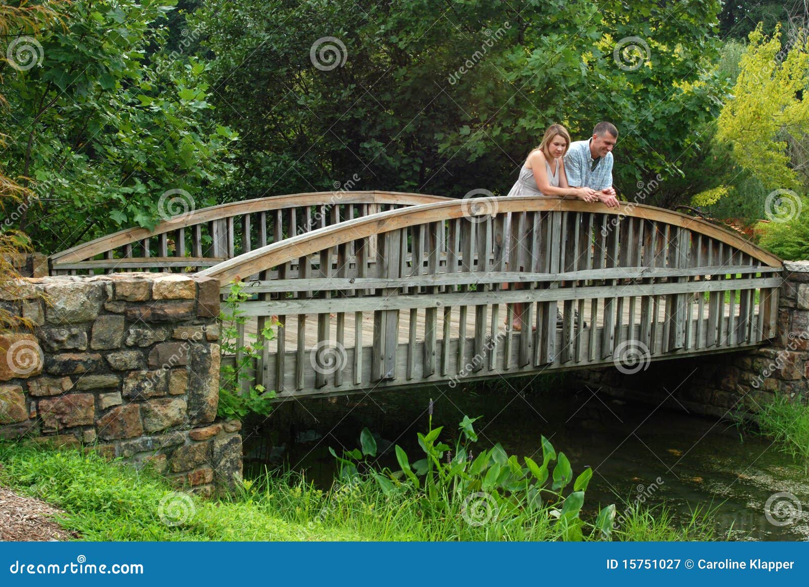 Man and Woman on a Bridge stock image. Image of water - 15751027