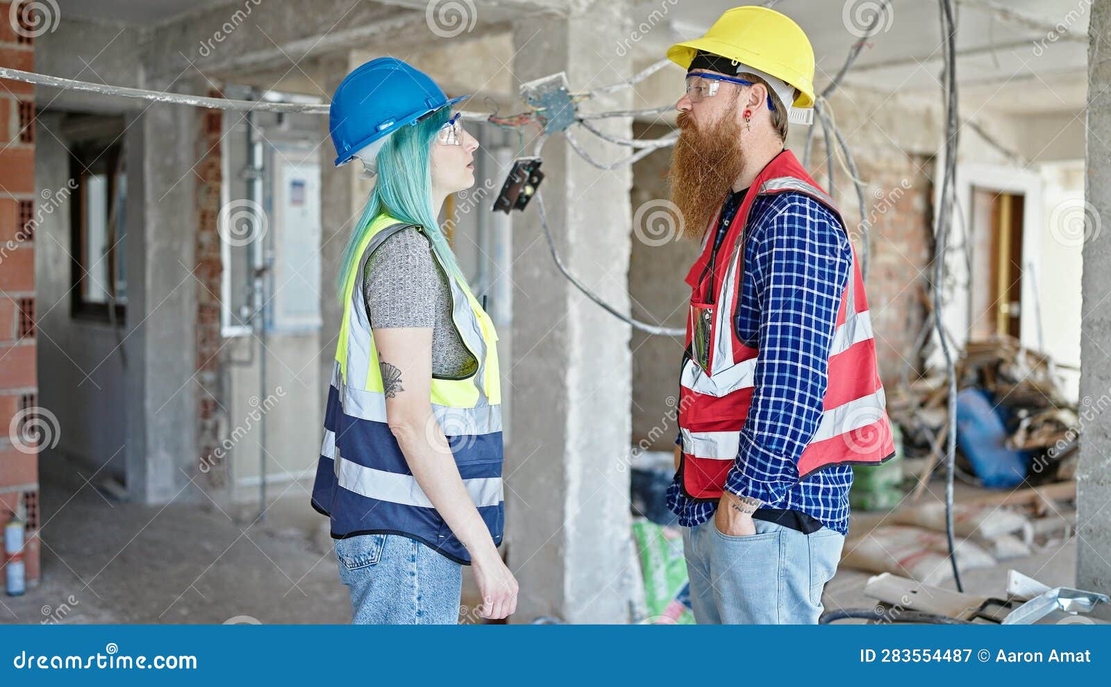 Man and Woman Builders Standing with Relaxed Expression Working at ...