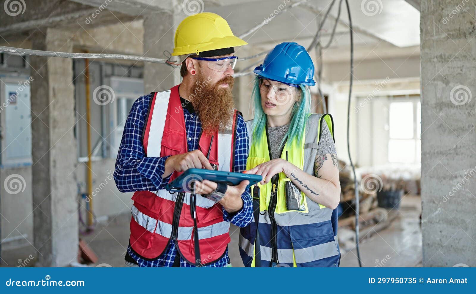 Man and Woman Builders Using Touchpad Working at Construction Site ...