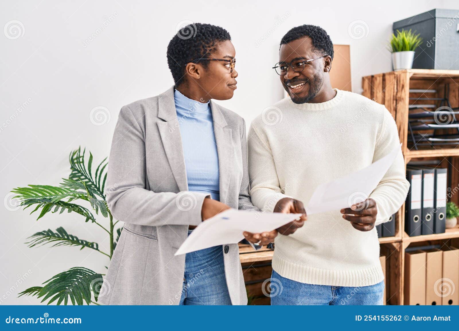 Man and Woman Business Workers Reading Paperwork at Office Stock Photo ...