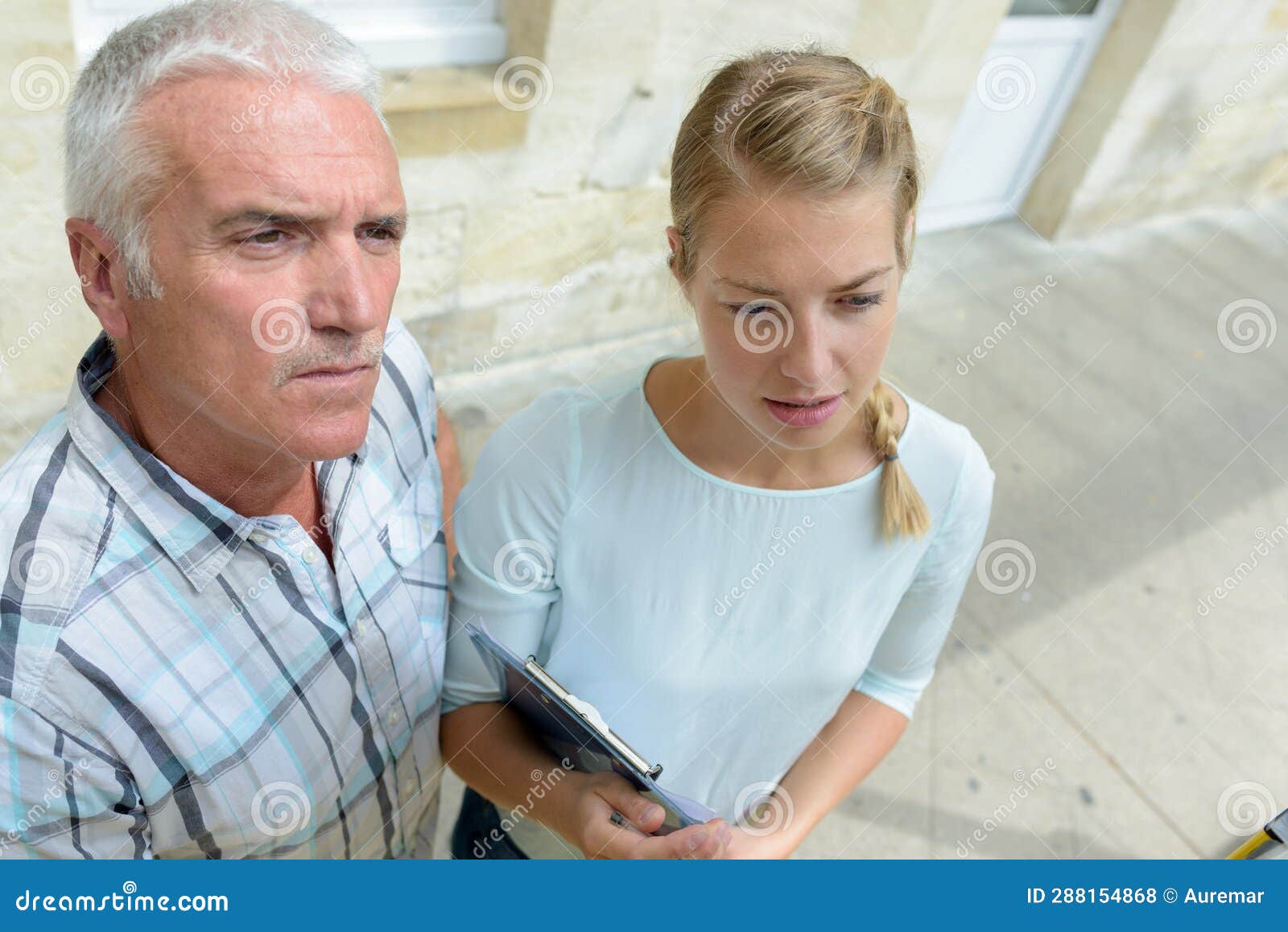Man and Woman Checking Something Outdoors Stock Photo - Image of ...