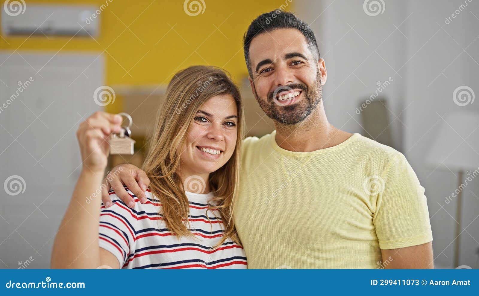 Man And Woman Couple Hugging Each Other Holding New House Keys At New