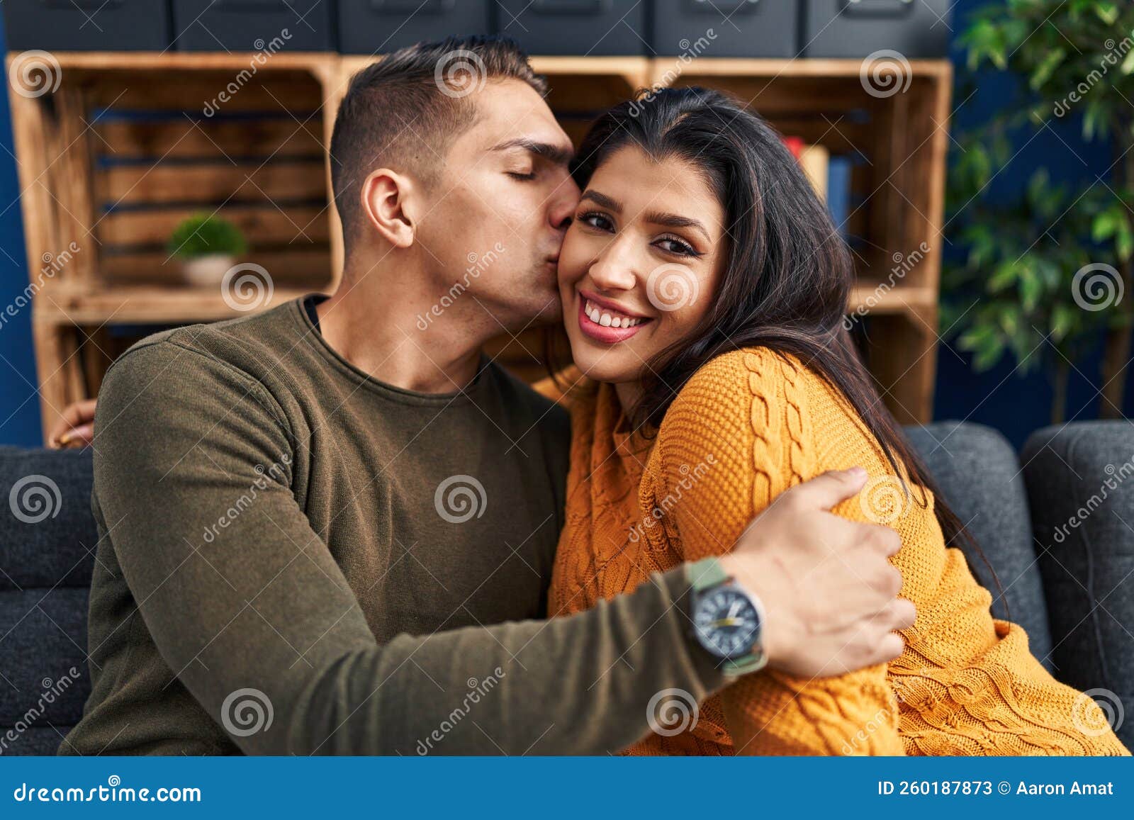 Man And Woman Couple Kissing And Hugging Each Other Sitting On Sofa At