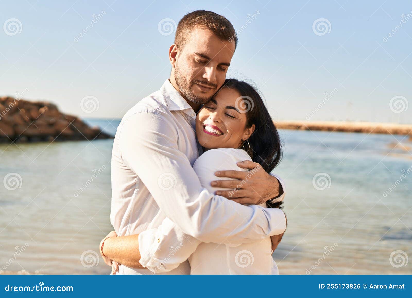 Man And Woman Couple Smiling Happy Hugging Each Other Standing At