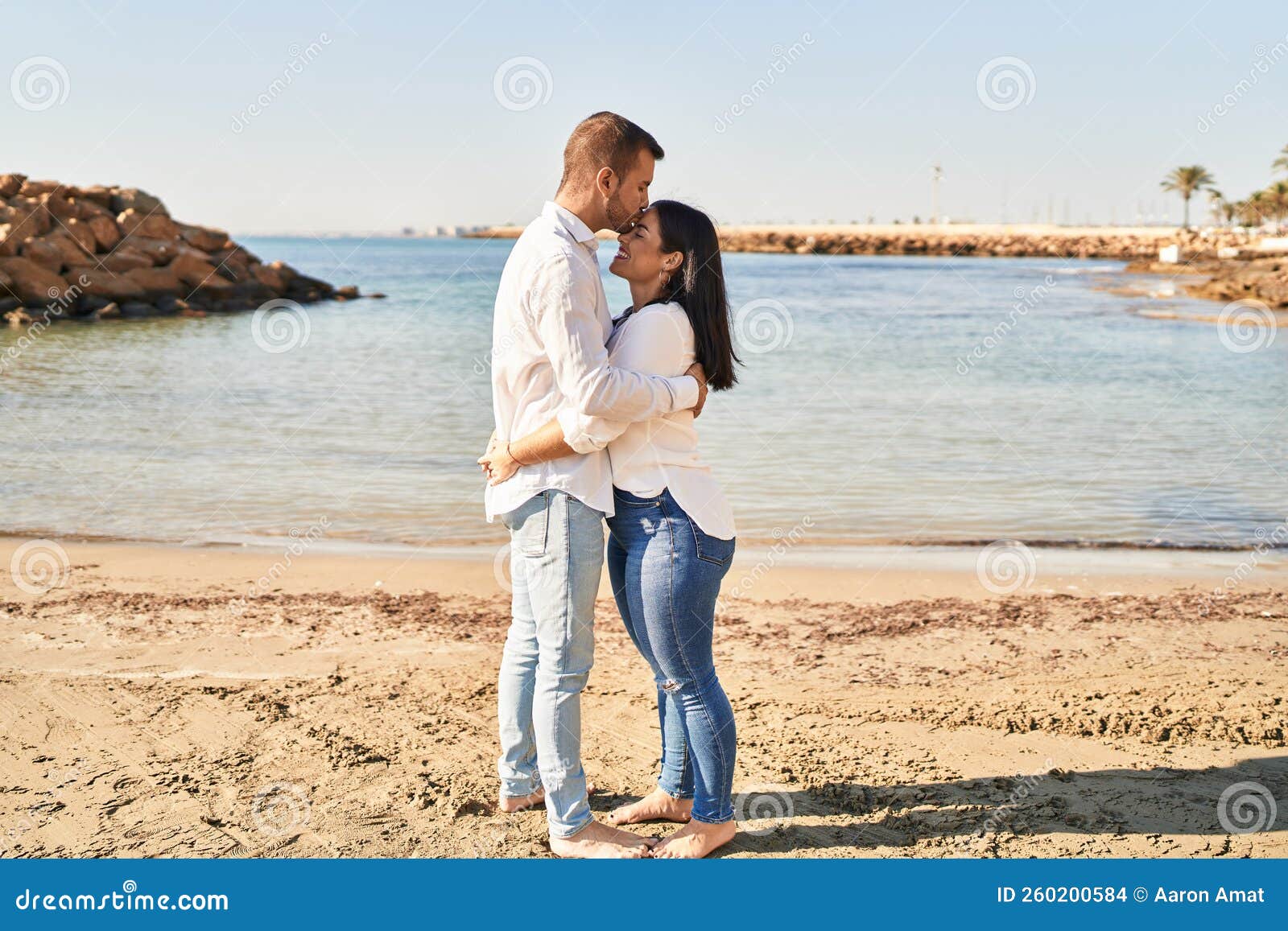 Man And Woman Couple Smiling Happy Hugging Each Other Standing At