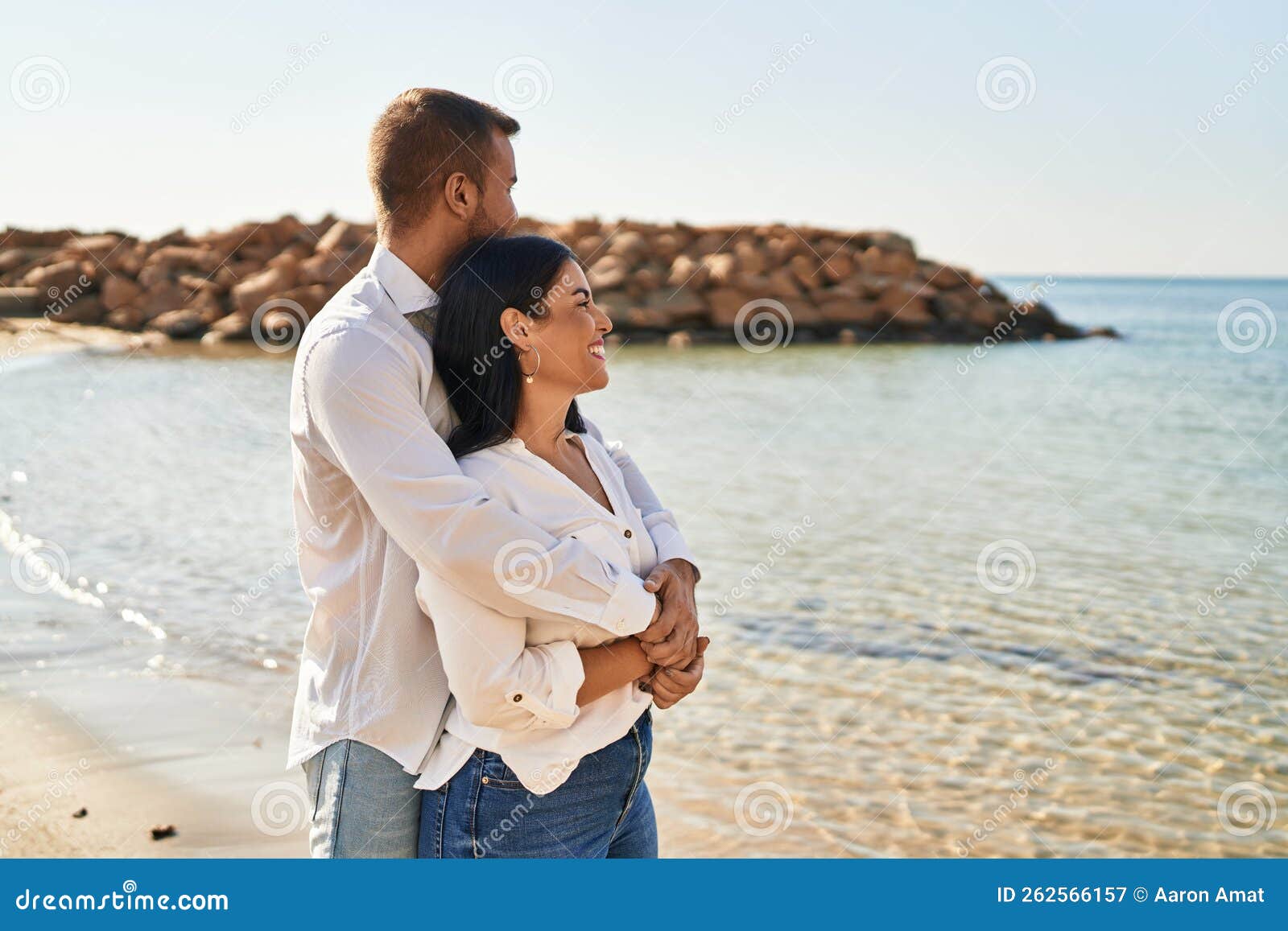 Man And Woman Couple Smiling Happy Hugging Each Other Standing At