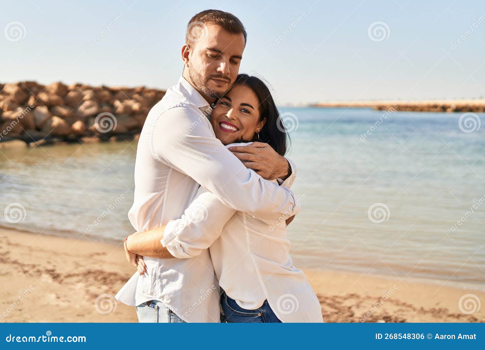 Man And Woman Couple Smiling Happy Hugging Each Other Standing At