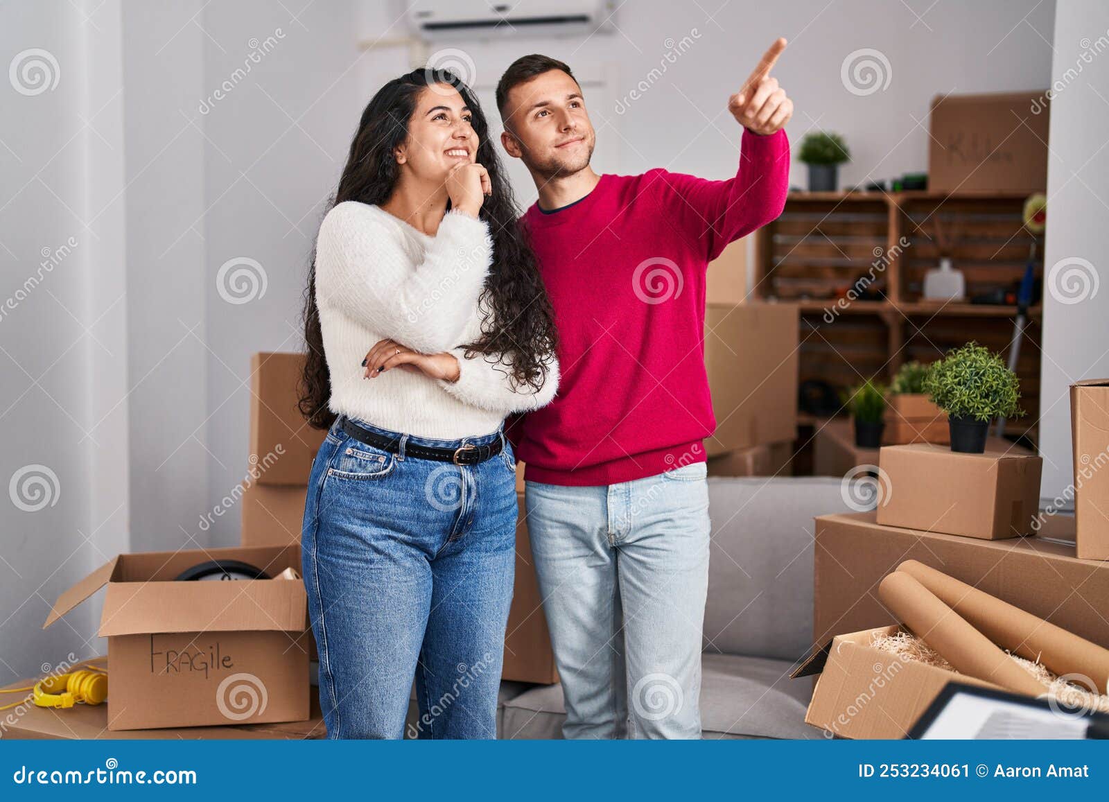 Man And Woman Couple Standing Together Pointing With Finger To The Side