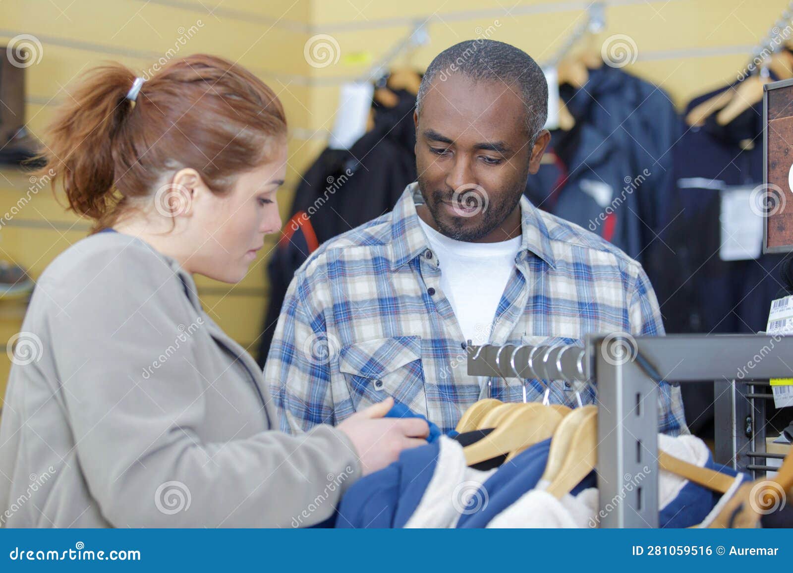 Man and Woman Deciding in Uniform Store Stock Photo - Image of menno ...