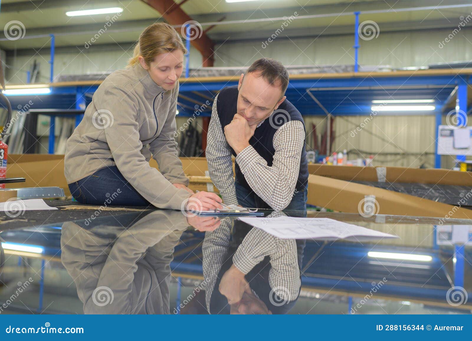 Man and Woman Discussing Something in Warehouse Stock Photo - Image of ...